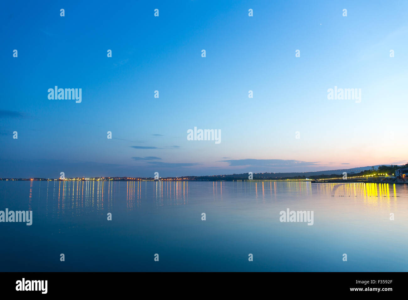 Night view of city embankment with reflections of light on water Stock ...