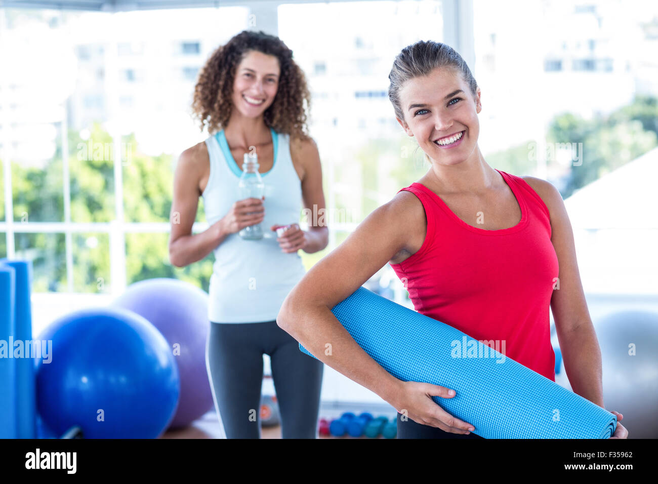 Portrait of happy women in fitness studio Stock Photo - Alamy