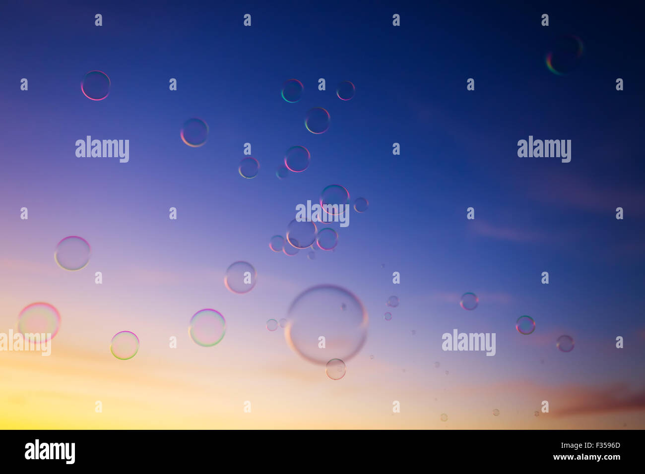 Background with soap bubbles floating in the sunset sky Stock Photo - Alamy