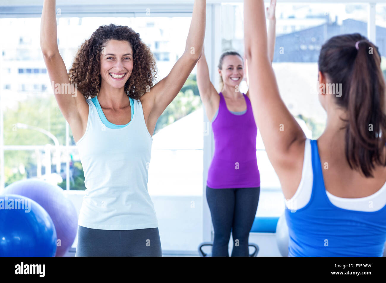 Cropped image of cheerful and fit women with arms raised Stock Photo ...