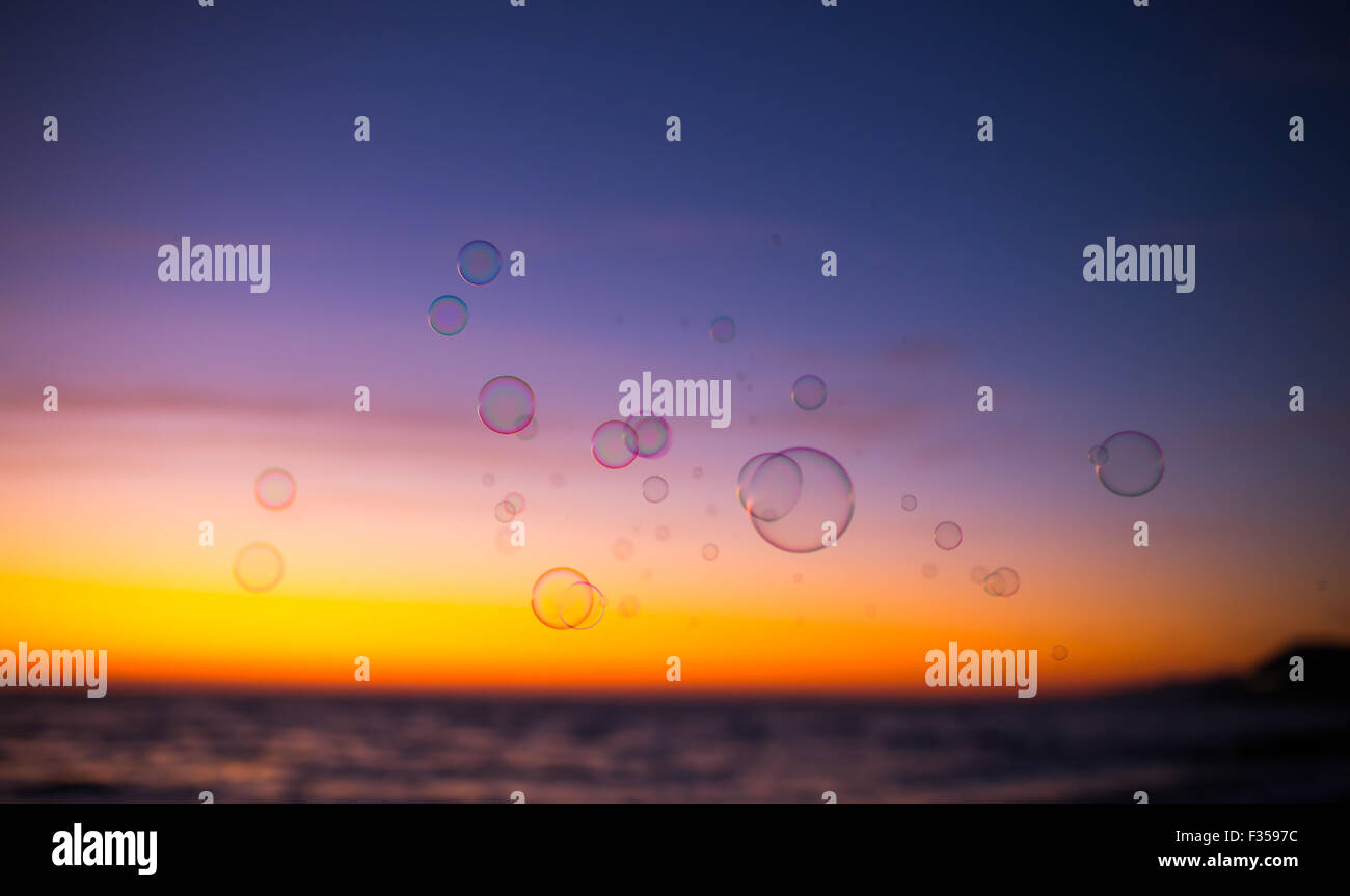 Background with soap bubbles floating in the sunset sky Stock Photo - Alamy