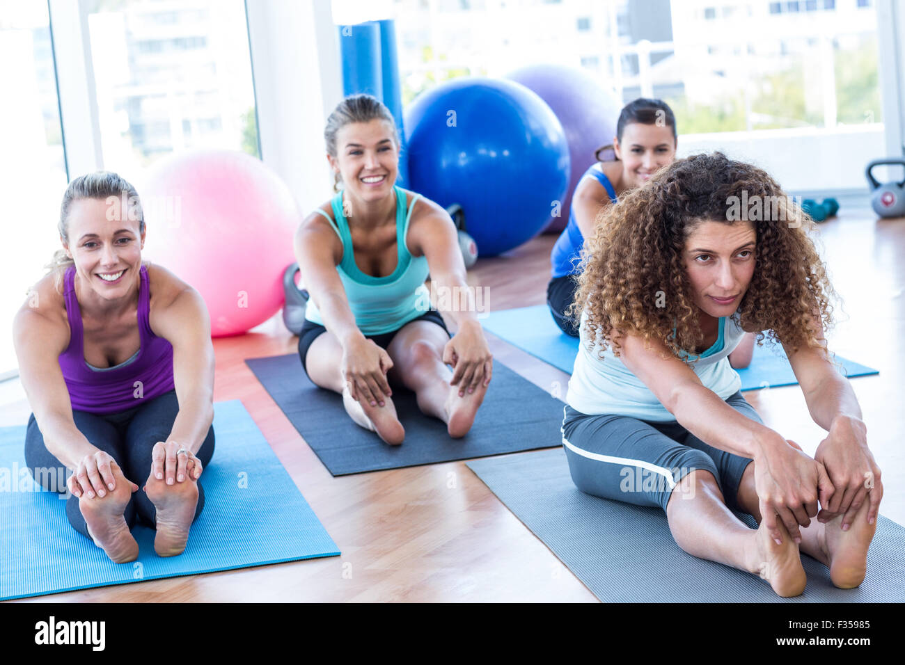 Woman sitting in forward bend pose Stock Photo - Alamy