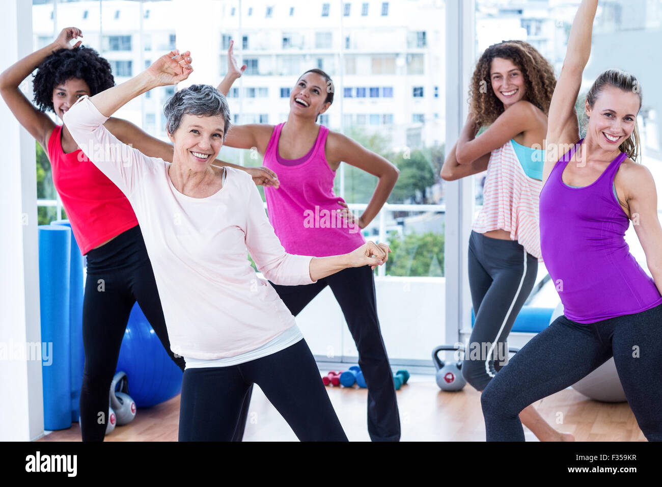 Cheerful women exercising with arms raised Stock Photo - Alamy