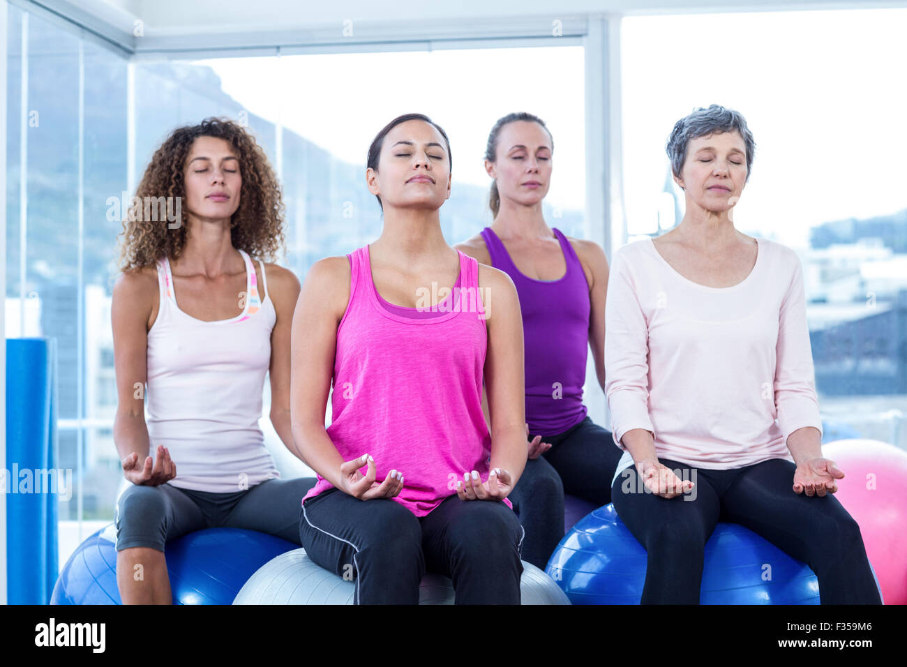 Women relaxing on exercise balls with eyes closed Stock Photo - Alamy