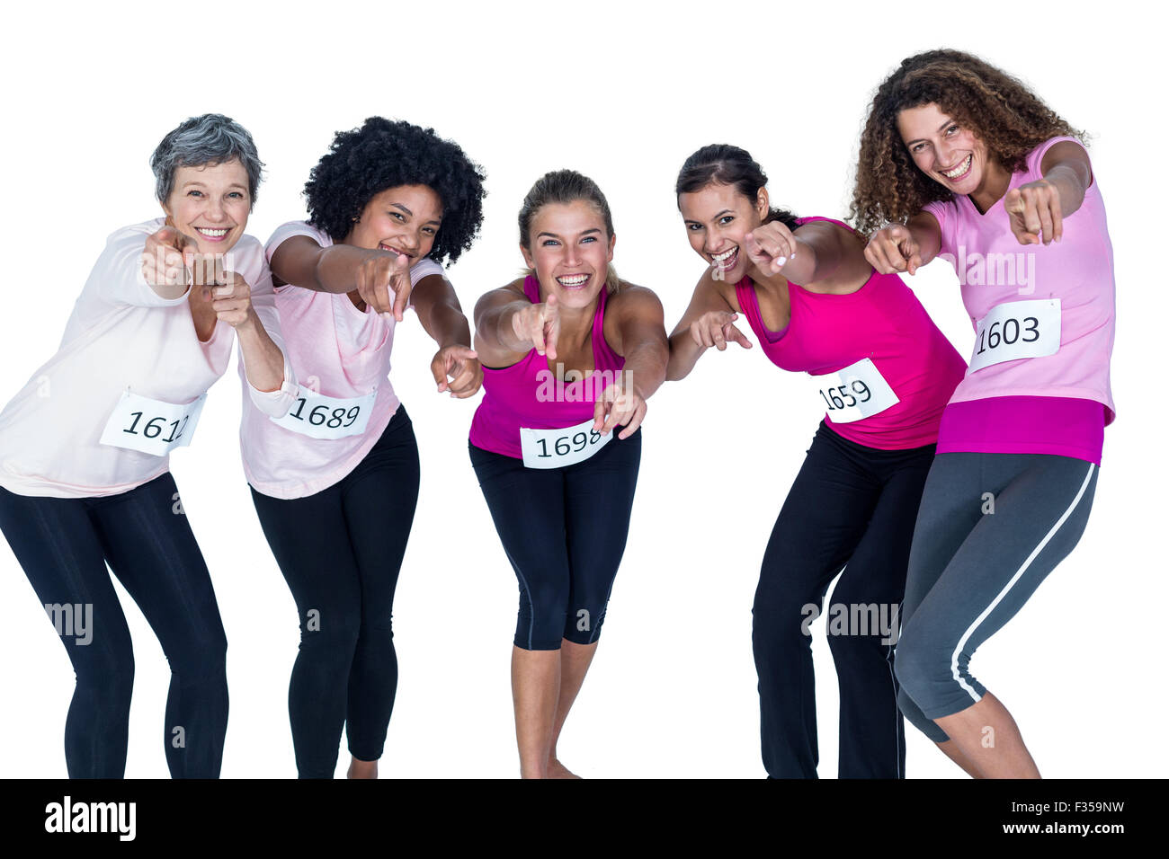 Portrait of smiling athletes pointing while bending Stock Photo - Alamy