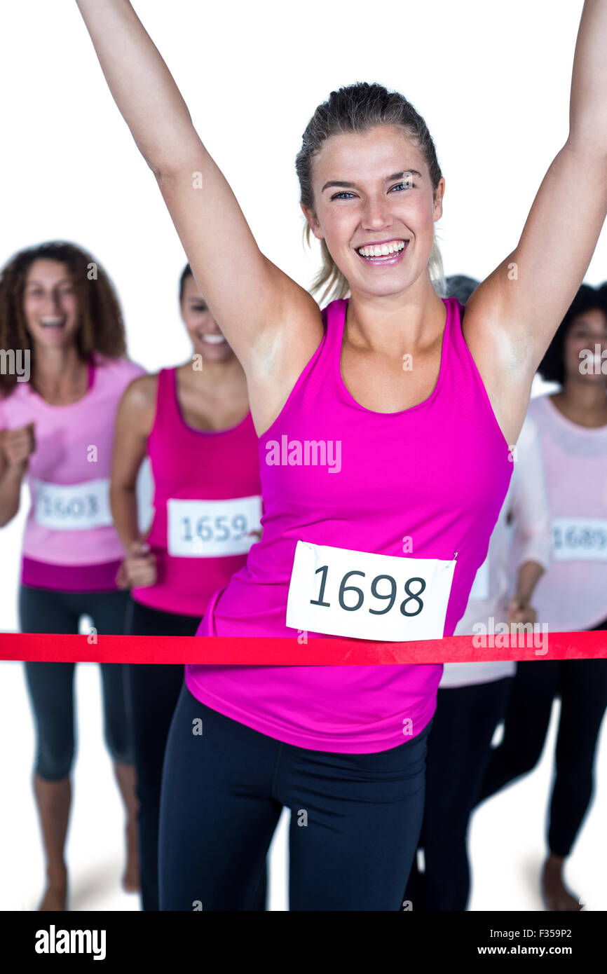 Portrait of smiling winner athlete crossing finish line Stock Photo - Alamy