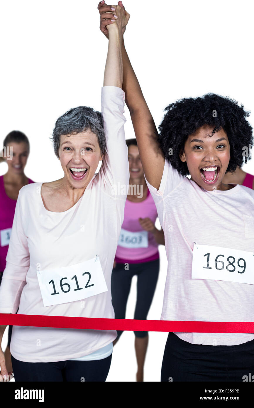Portrait of smiling winner athletes crossing finish line Stock Photo ...