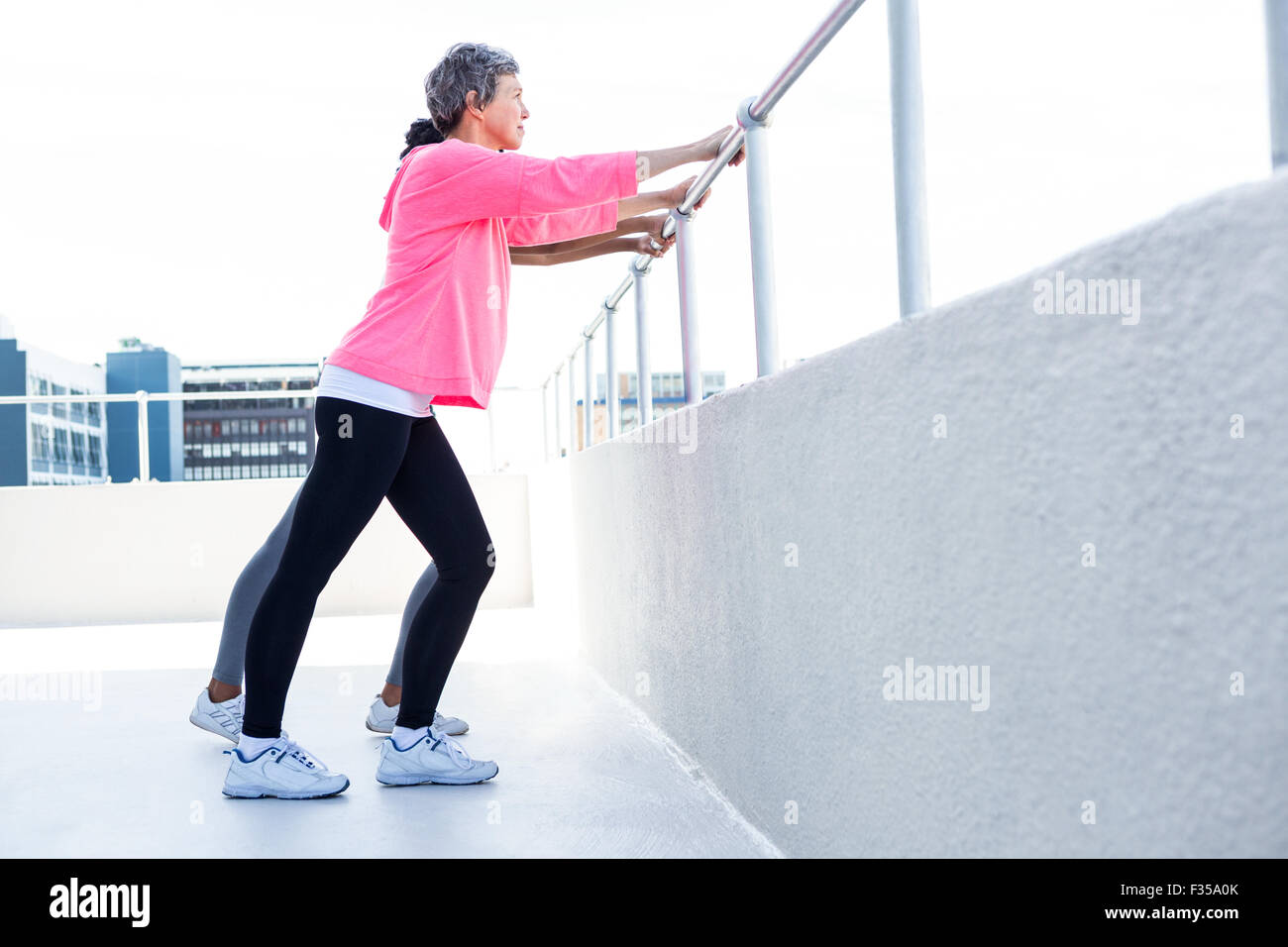 Women leaning on railing while exercising Stock Photo - Alamy