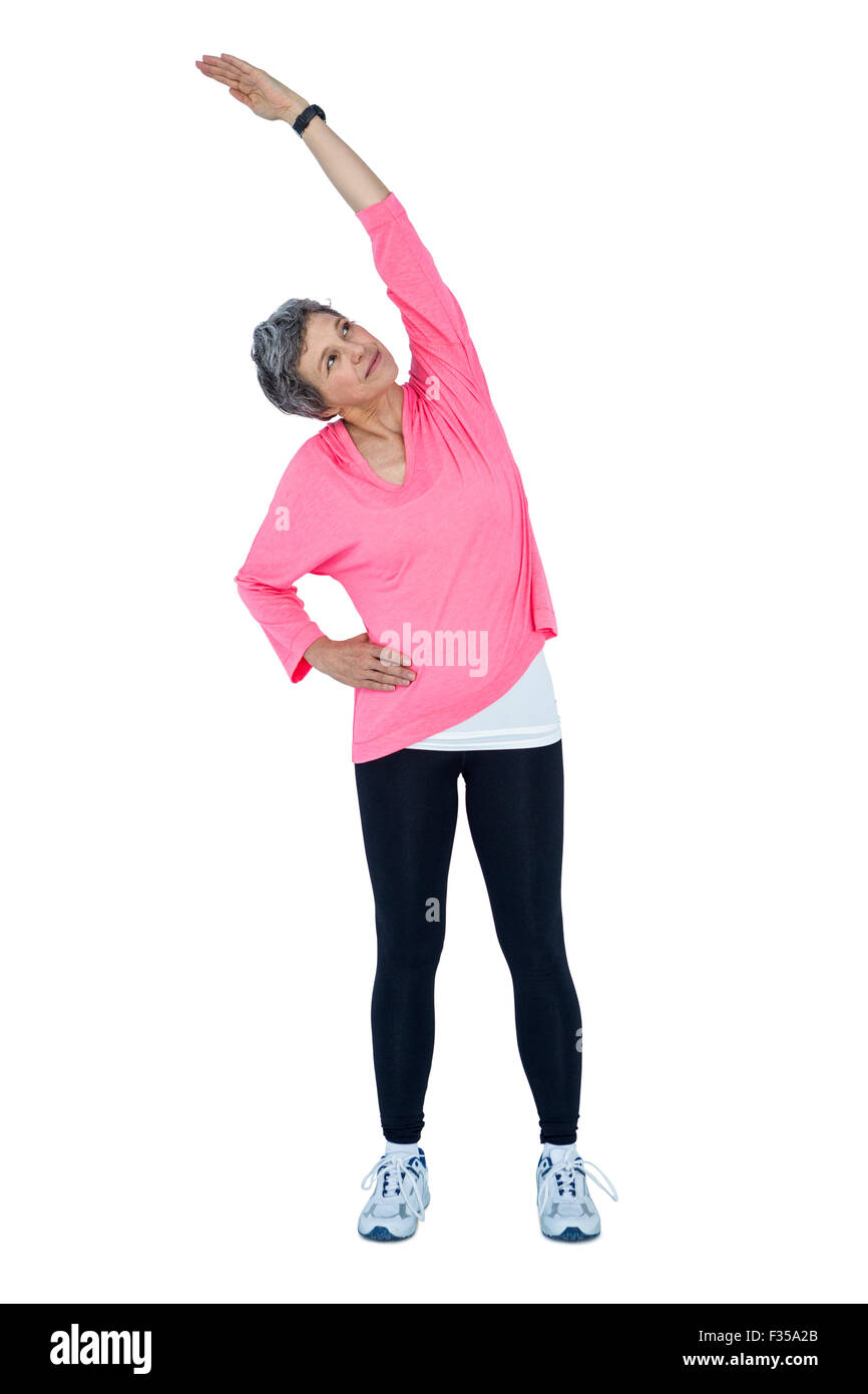 Mature woman looking up while stretching Stock Photo - Alamy