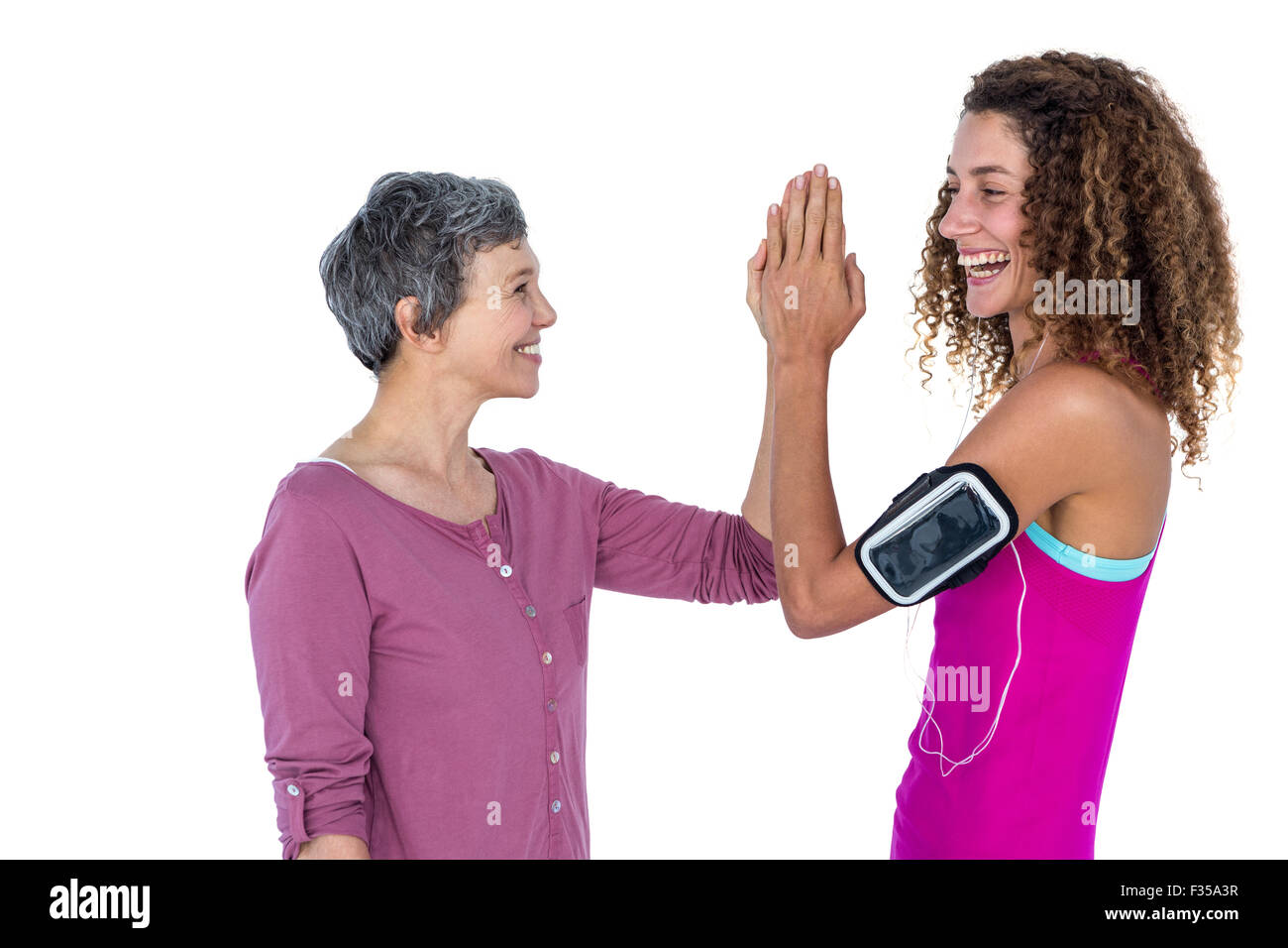Cheerful women high fiving Stock Photo - Alamy