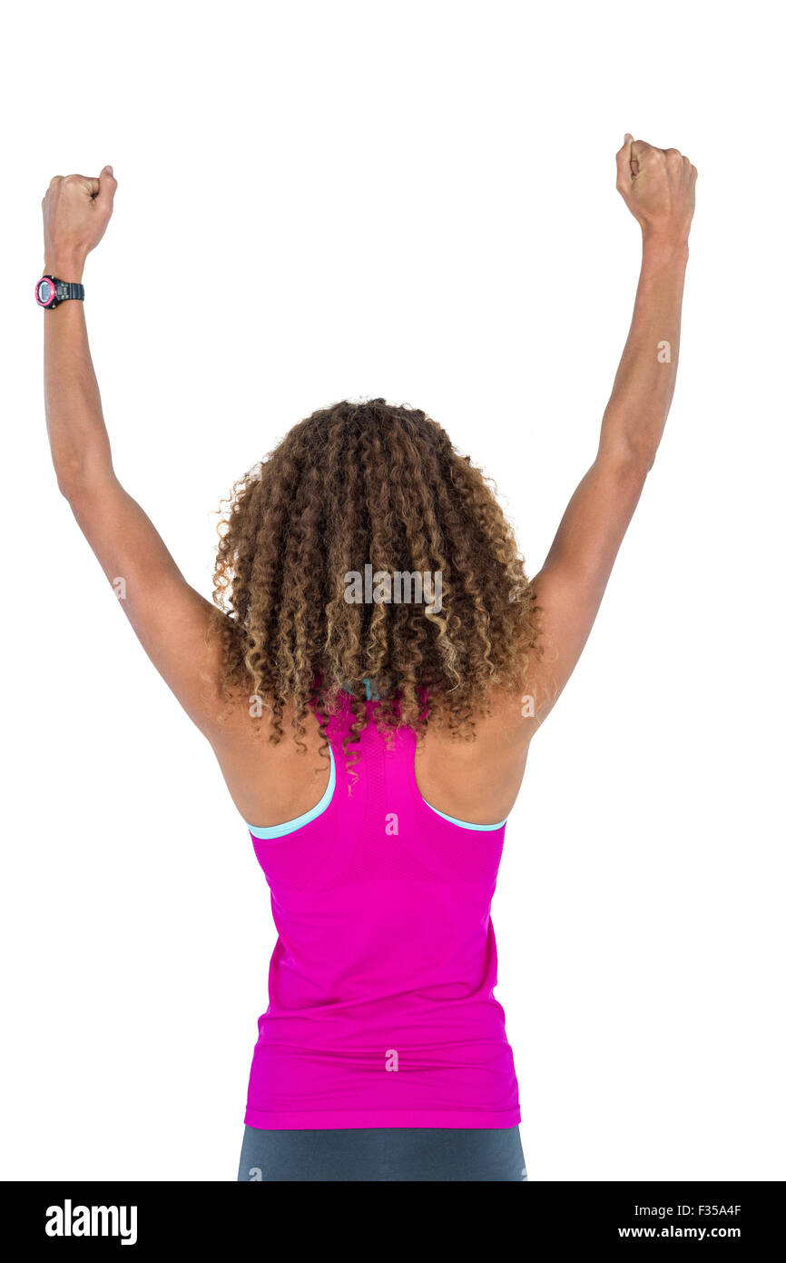 Rear view of woman cheering with arms raised Stock Photo - Alamy