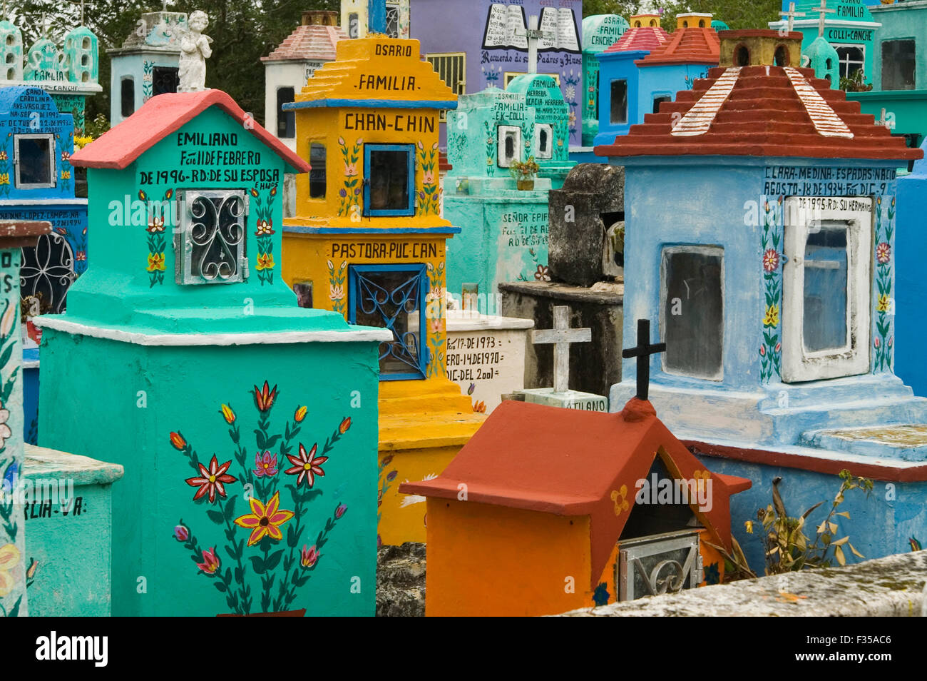 Colorful cemetery with bright paint on headstones with floral designs ...