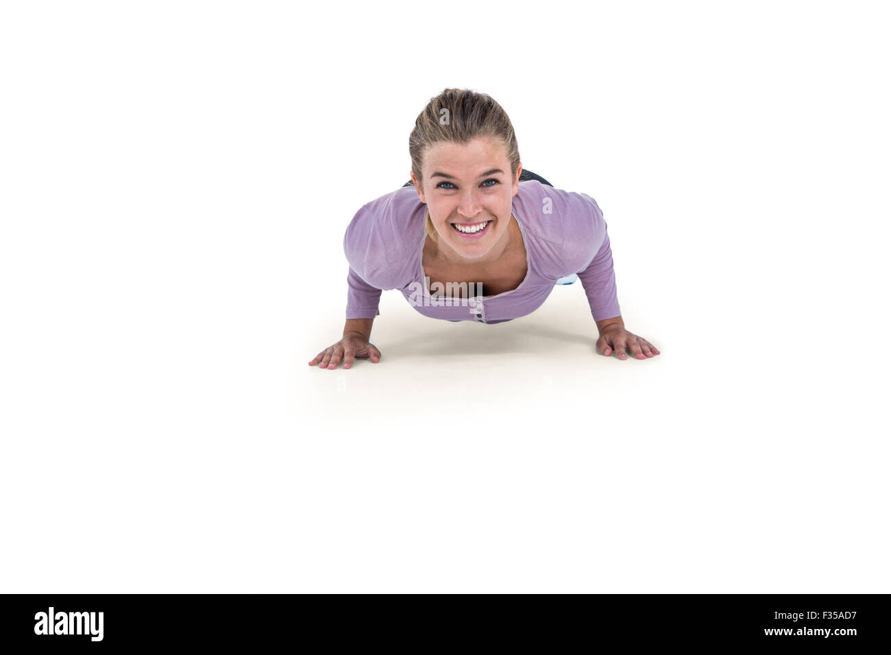 Portrait of happy young woman doing push ups Stock Photo - Alamy
