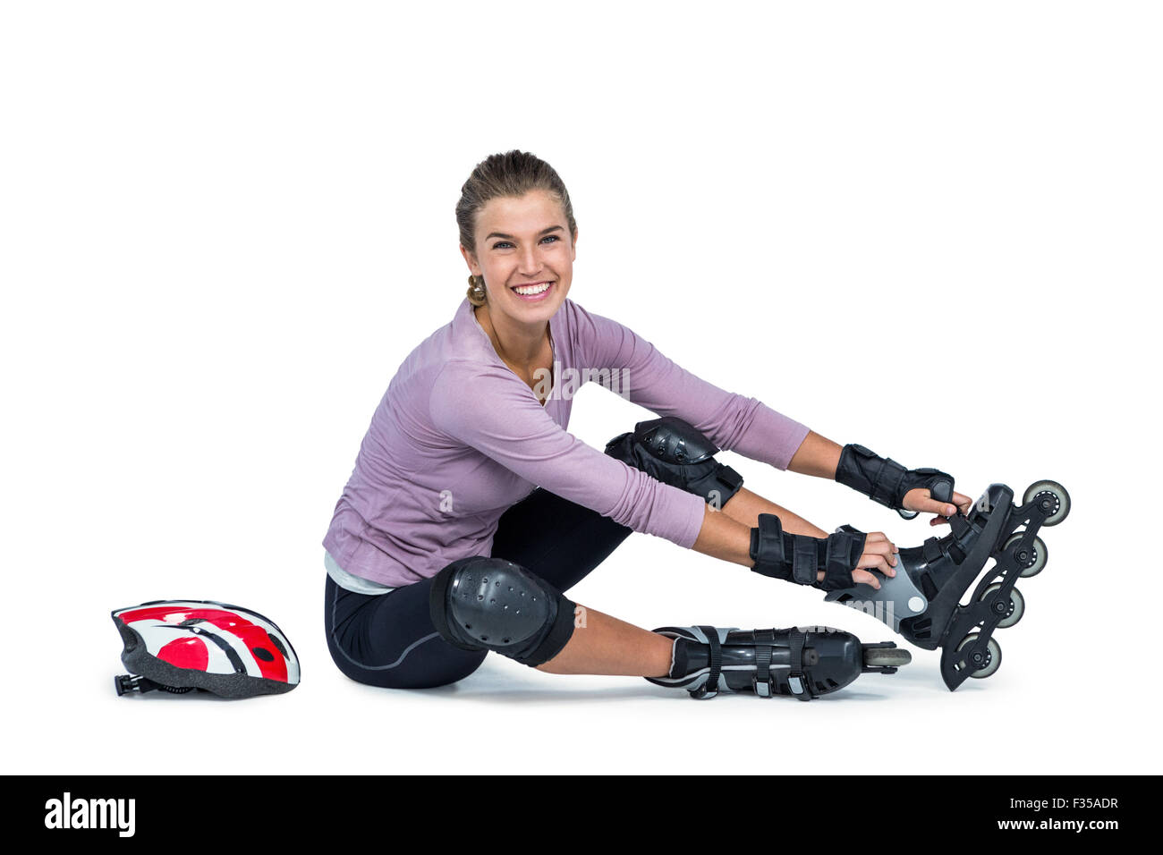 Portrait of happy woman wearing inline skates Stock Photo - Alamy