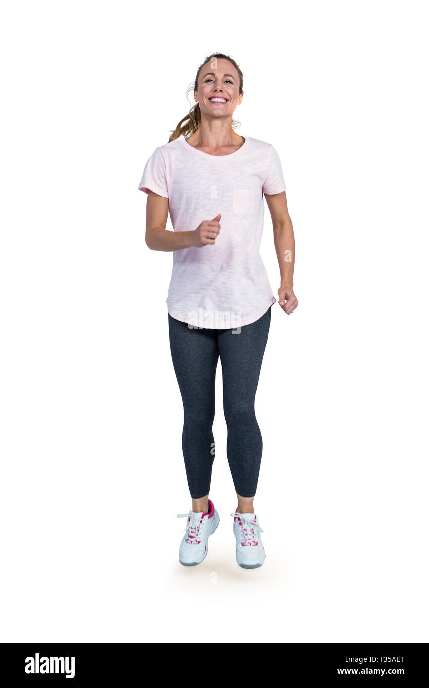 Young woman jogging over white background Stock Photo - Alamy