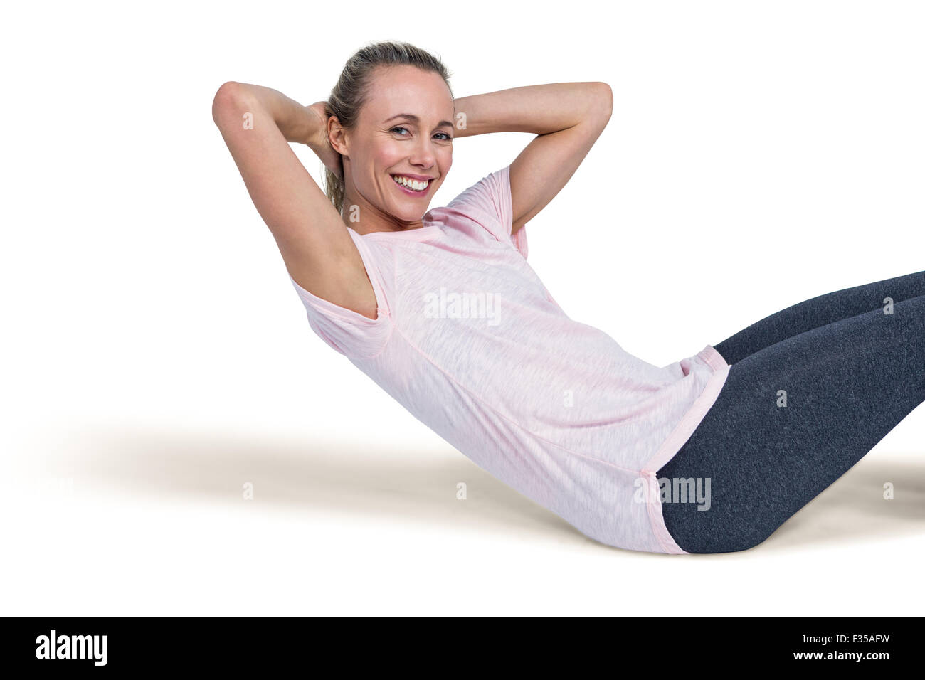 Portrait of happy sporty woman doing sit ups Stock Photo - Alamy