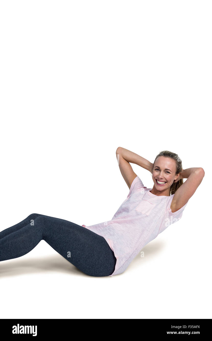 Portrait of cheerful sporty woman doing sit ups Stock Photo - Alamy