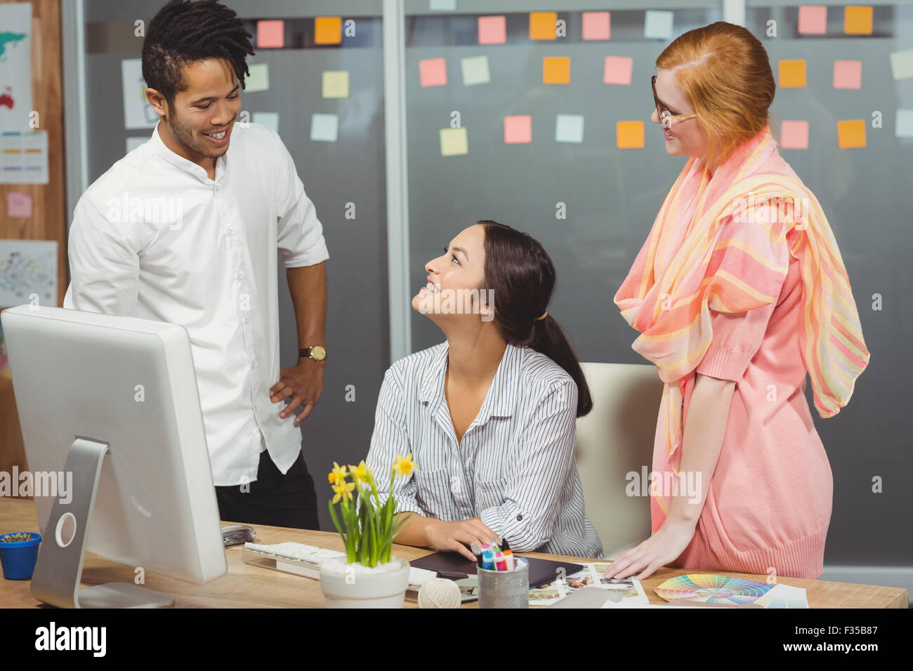 Happy business people using computer in office Stock Photo - Alamy