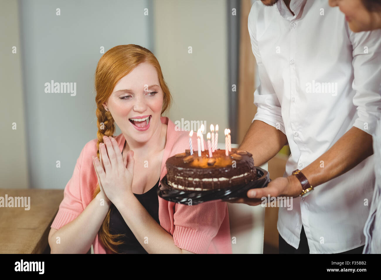 Happy woman looking at cake Stock Photo - Alamy