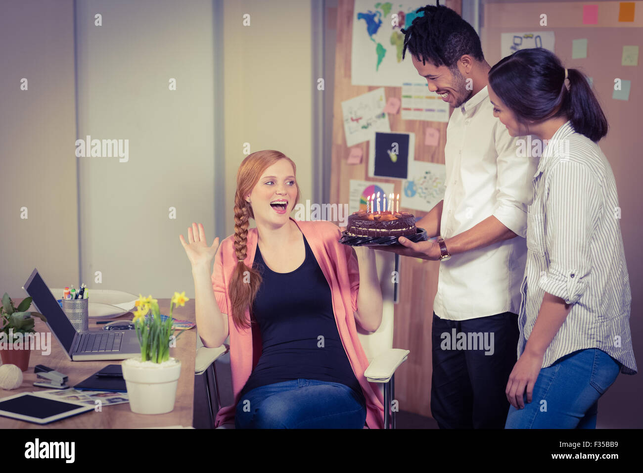 Surprised woman seeing birthday cake Stock Photo - Alamy