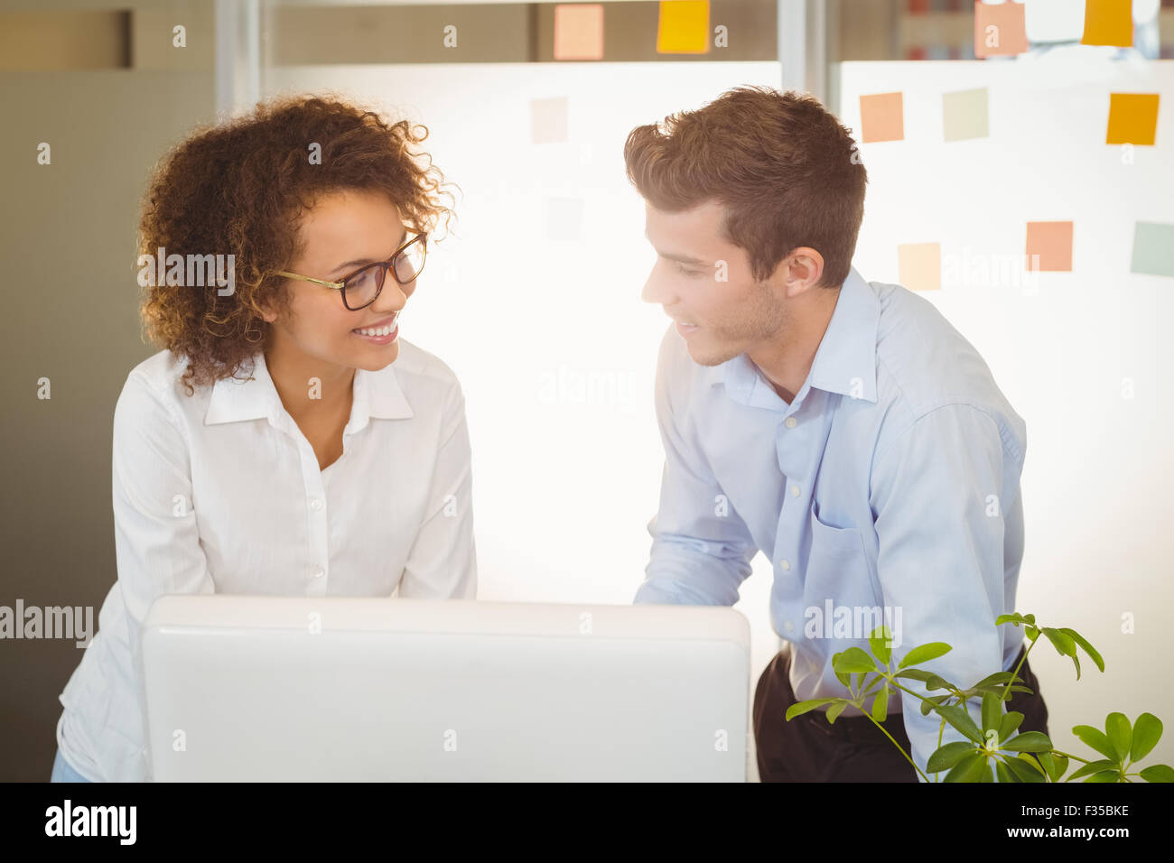 Business people standing by table in office Stock Photo - Alamy