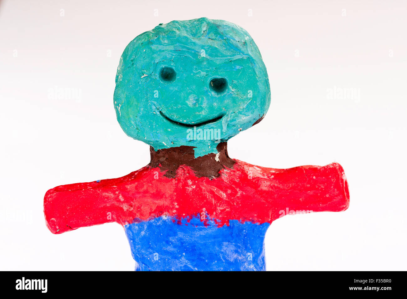 Young child made plasticine, clay model of a happy smiling man with ...