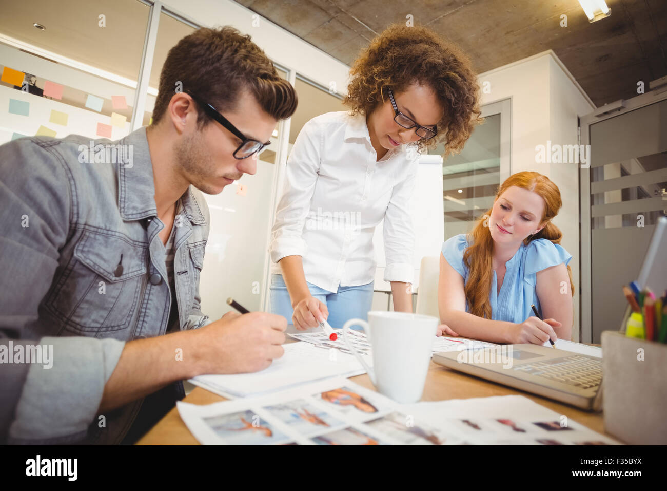 Business people looking at documents Stock Photo - Alamy