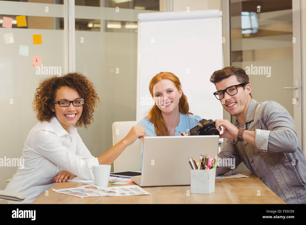 Business people with camera and laptop in meeting Stock Photo - Alamy