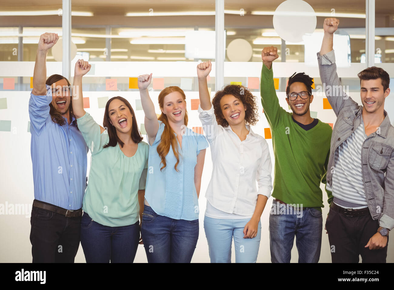 Excited business people with arm raised Stock Photo - Alamy