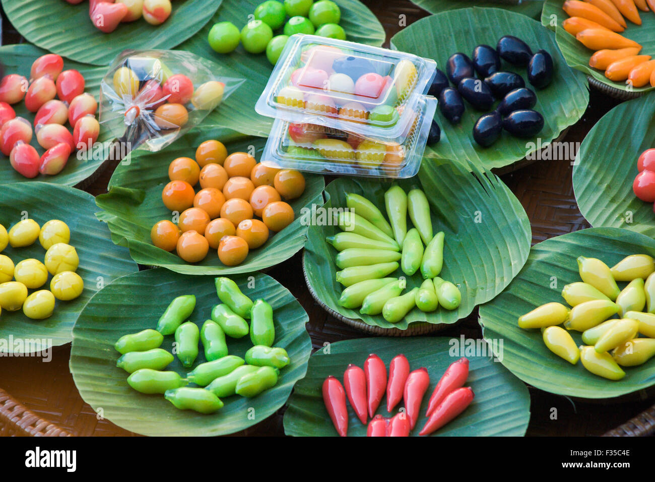 Colorful fruit separated in round leaves, street food, Bangkok ...