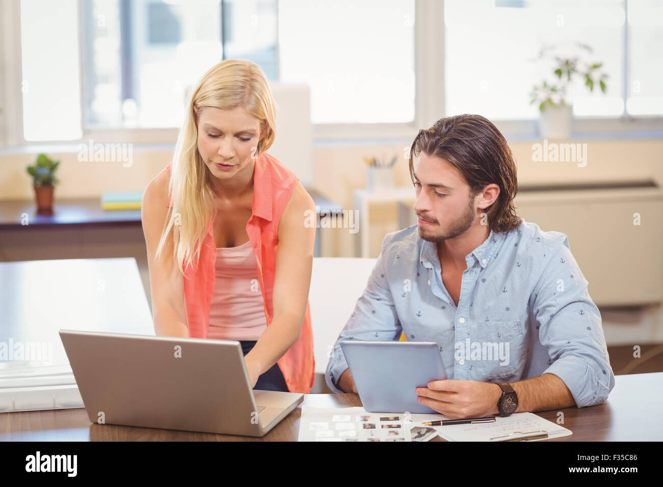 Business people looking at documents Stock Photo - Alamy