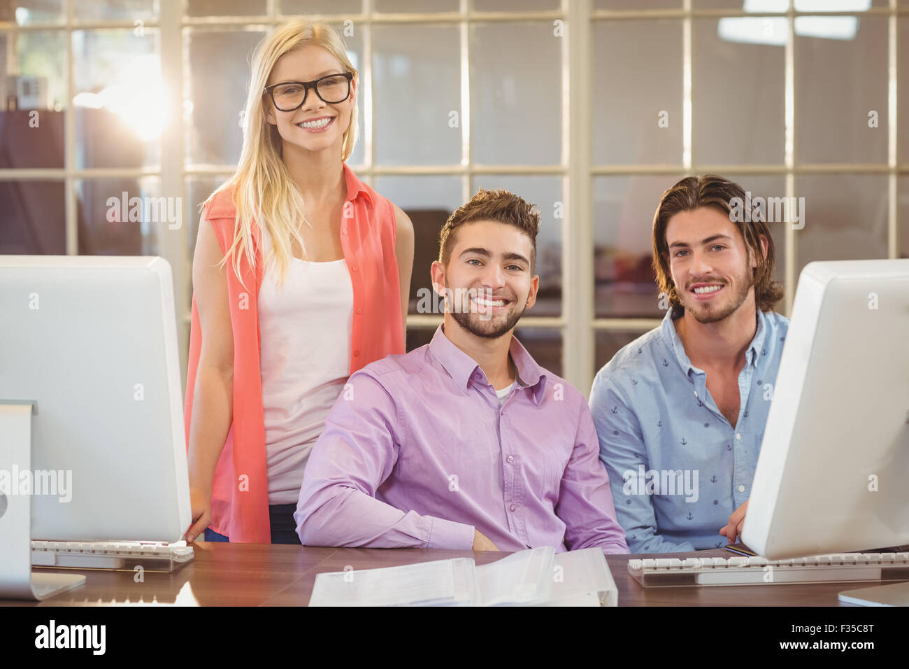 Stylish business people sitting by computer Stock Photo - Alamy
