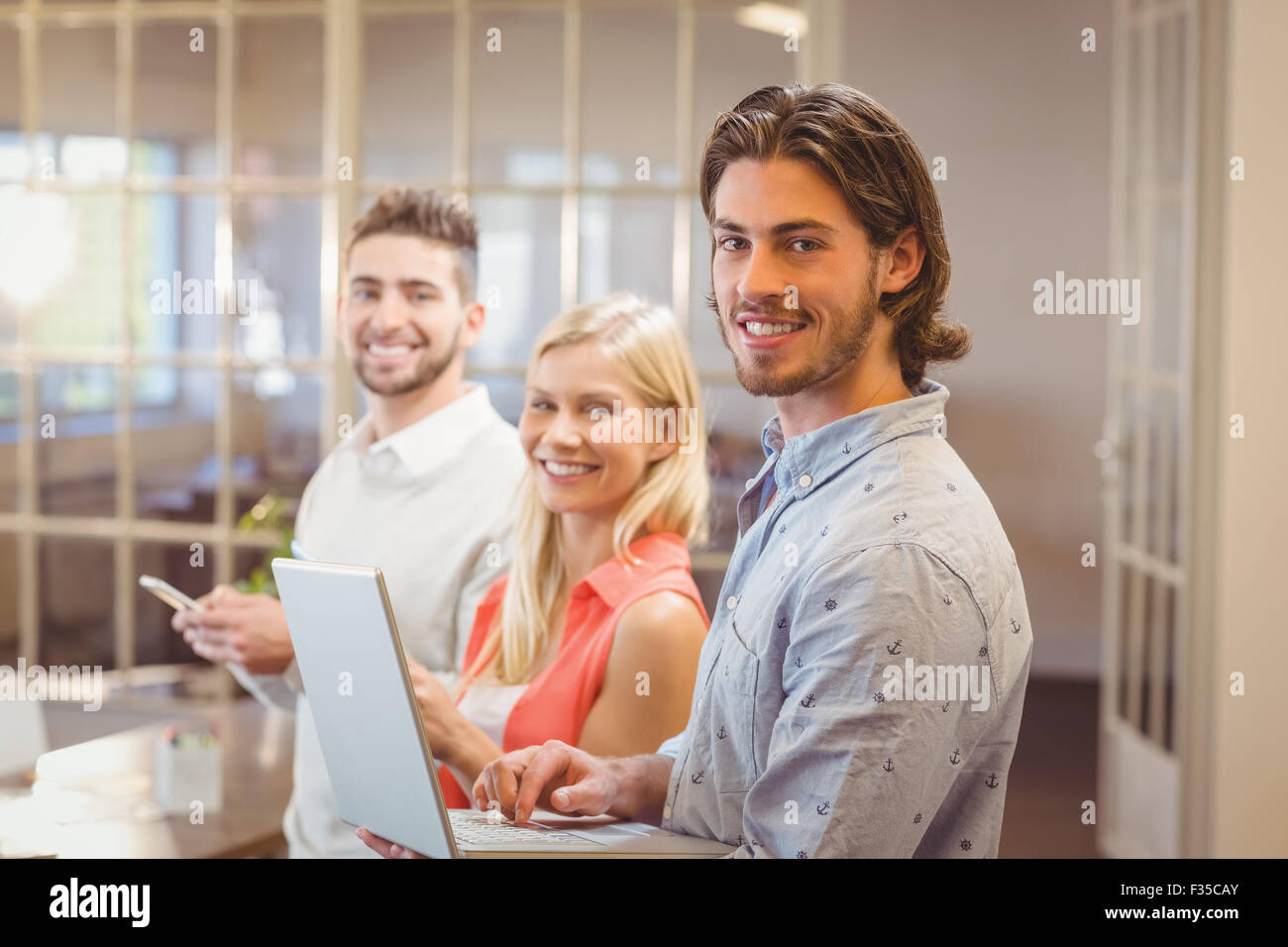Portrait of happy business people working Stock Photo - Alamy
