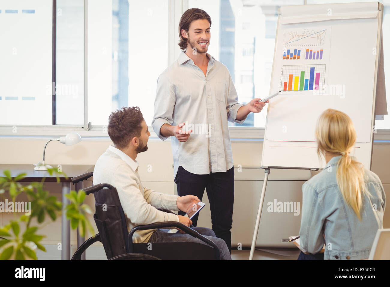 Businessman giving presentation to colleagues Stock Photo - Alamy