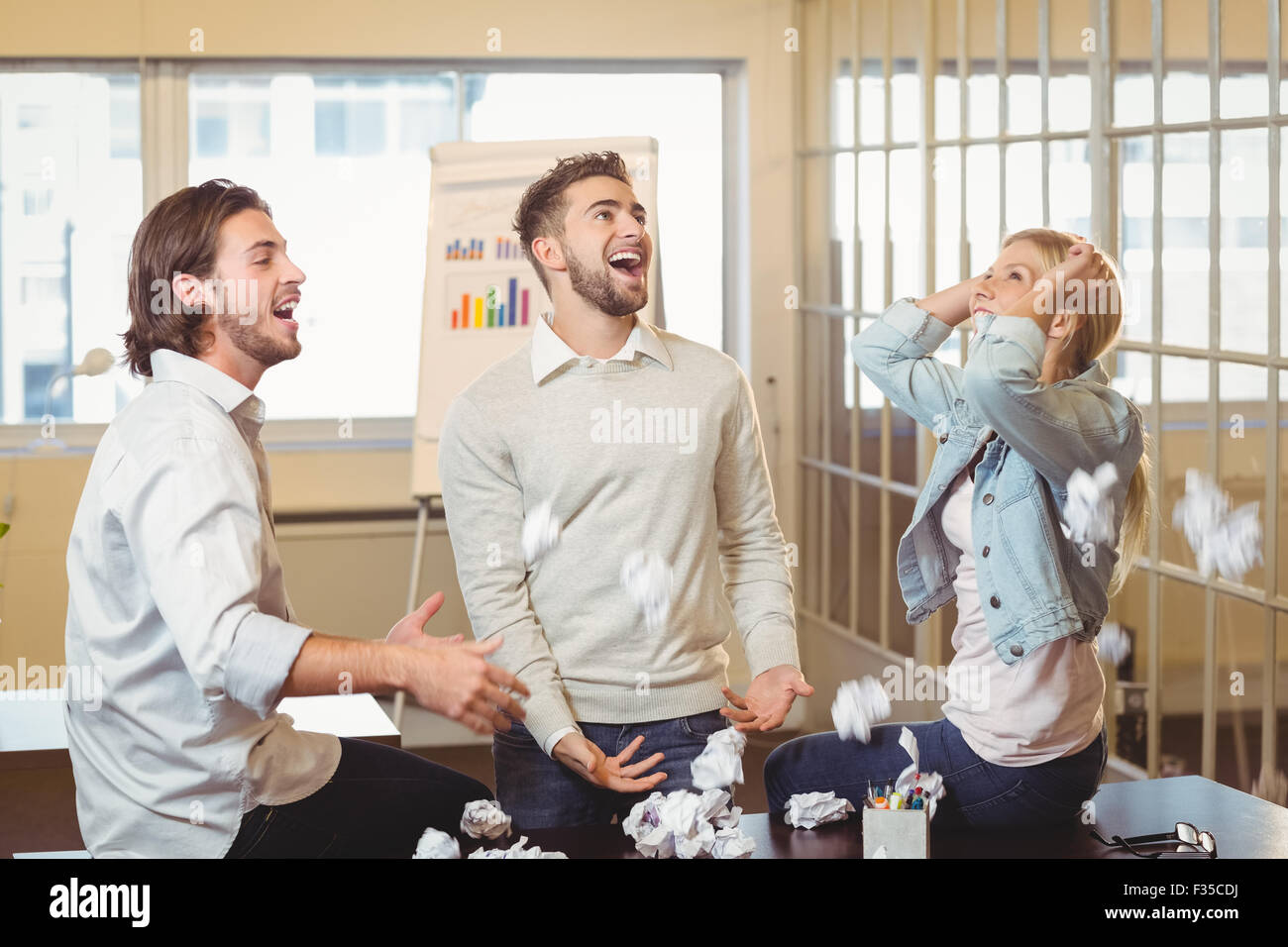 Business people playing with paper balls Stock Photo - Alamy