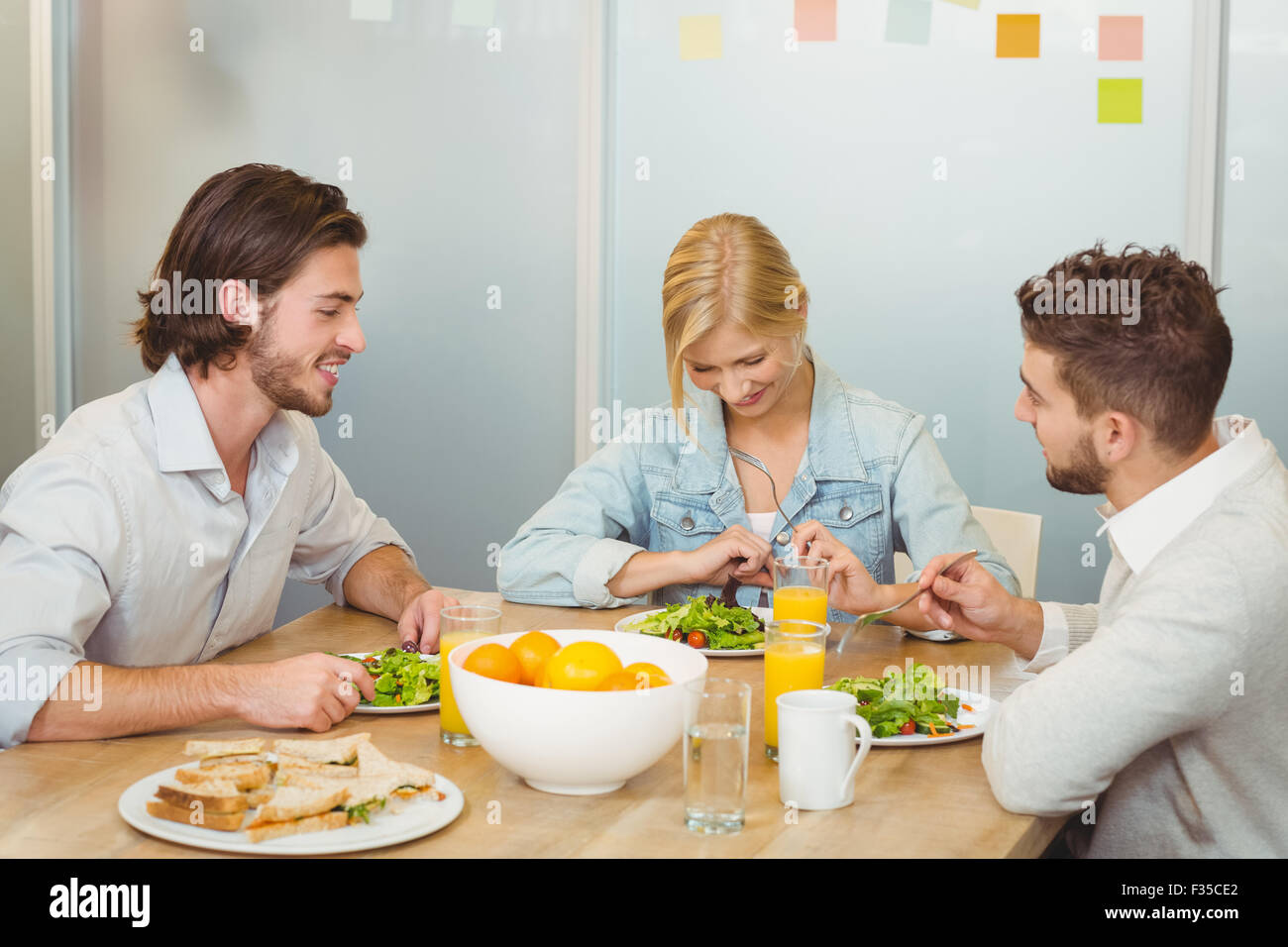 Business people having lunch in office Stock Photo - Alamy