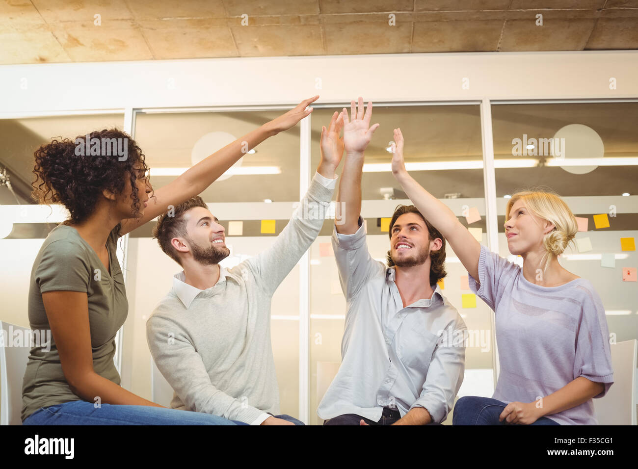 Business people with arm raised in meeting Stock Photo - Alamy