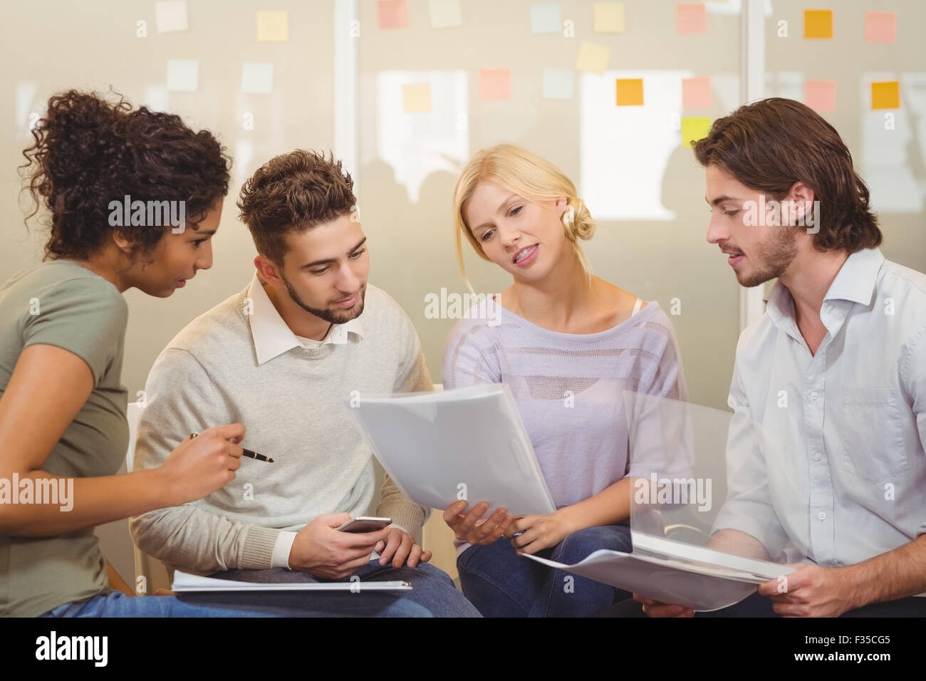 Business people looking at documents Stock Photo - Alamy