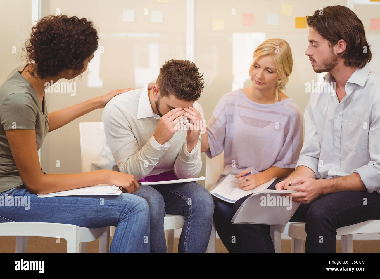 Stressed worker with her colleagues Stock Photo - Alamy