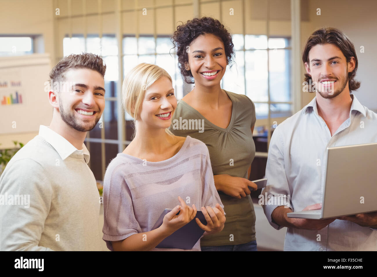 Portrait of smiling colleagues in office Stock Photo - Alamy