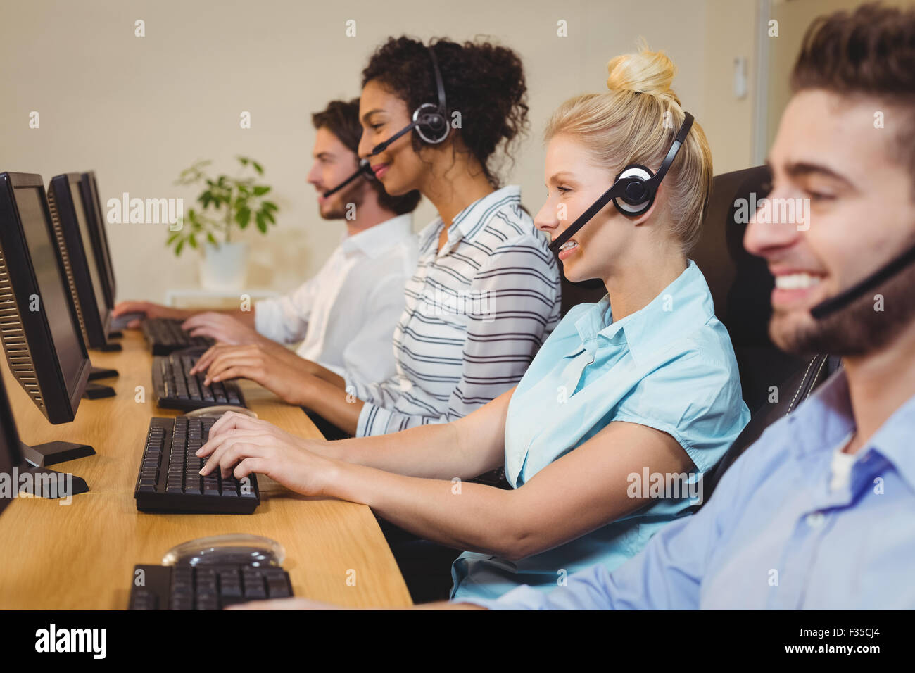 Smiling executives working in call center Stock Photo - Alamy