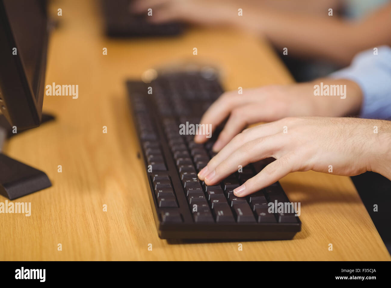 Cropped hands of executive on keyboard in office Stock Photo - Alamy