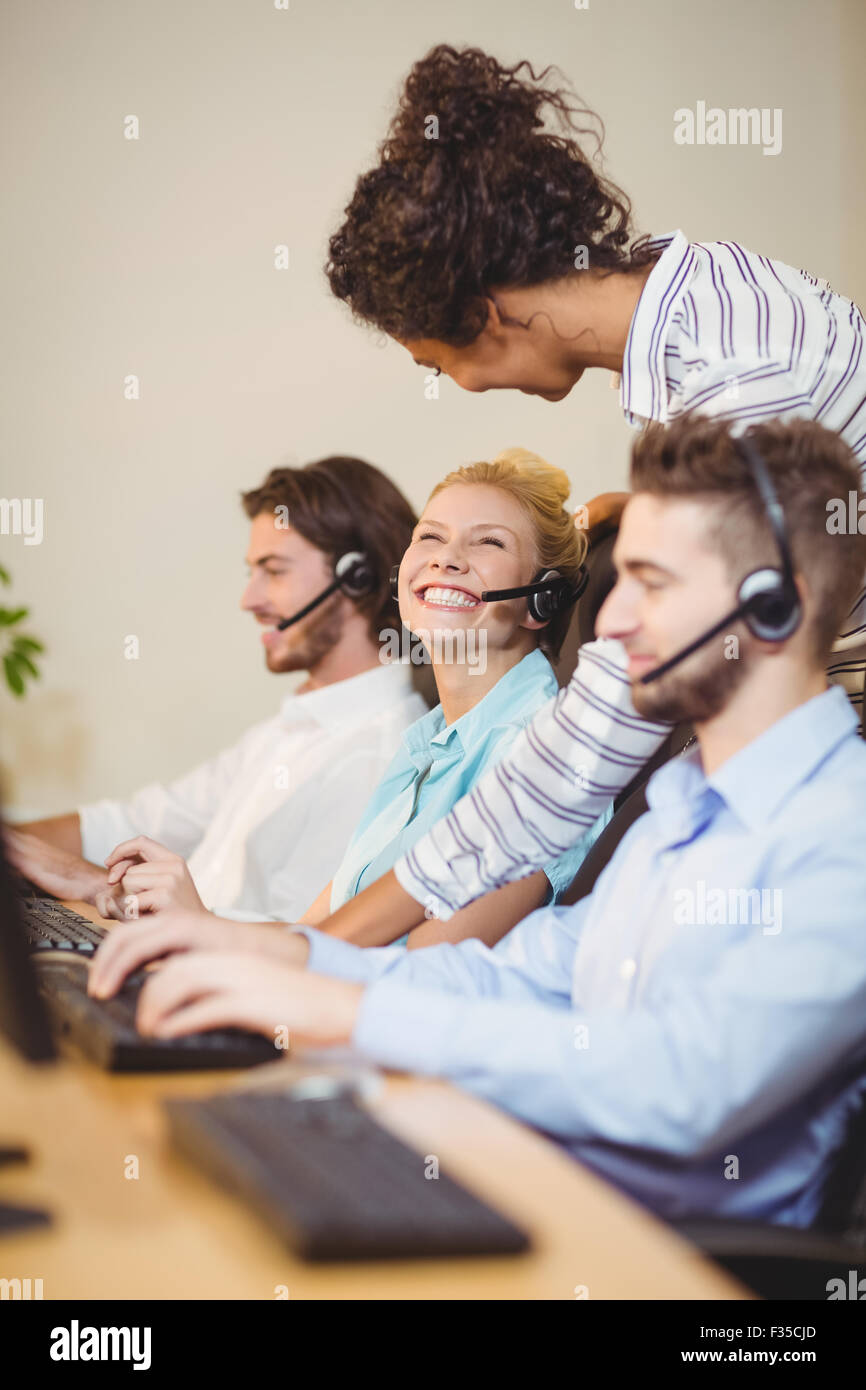 Businesswoman interacting female employee Stock Photo - Alamy