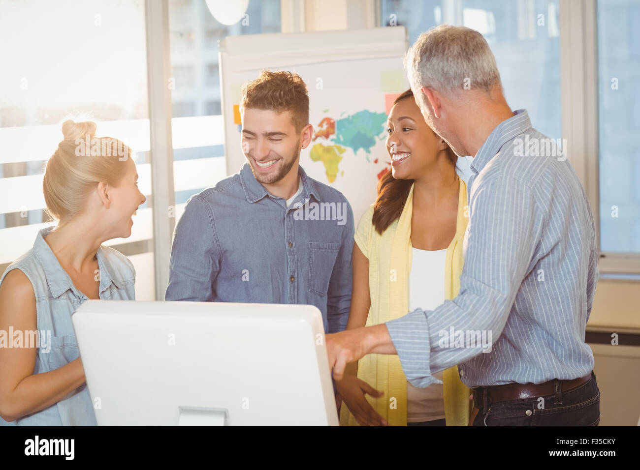Smiling business people using computer in meeting room Stock Photo - Alamy