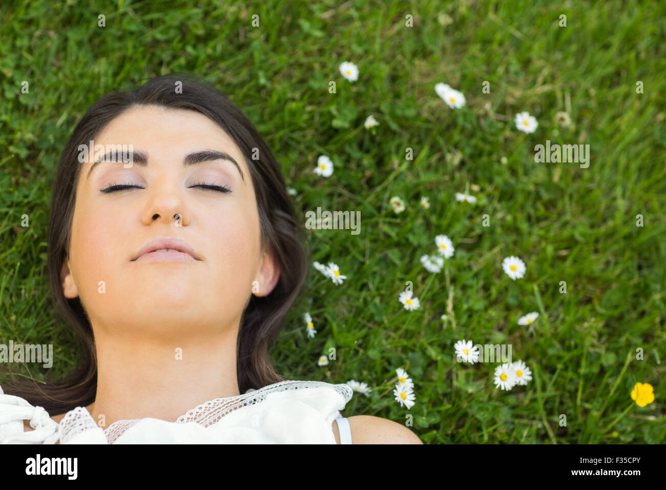 Beautiful young woman relaxing on grassland Stock Photo - Alamy Beautiful young woman relaxing on grassland Stock Photo - Alamy