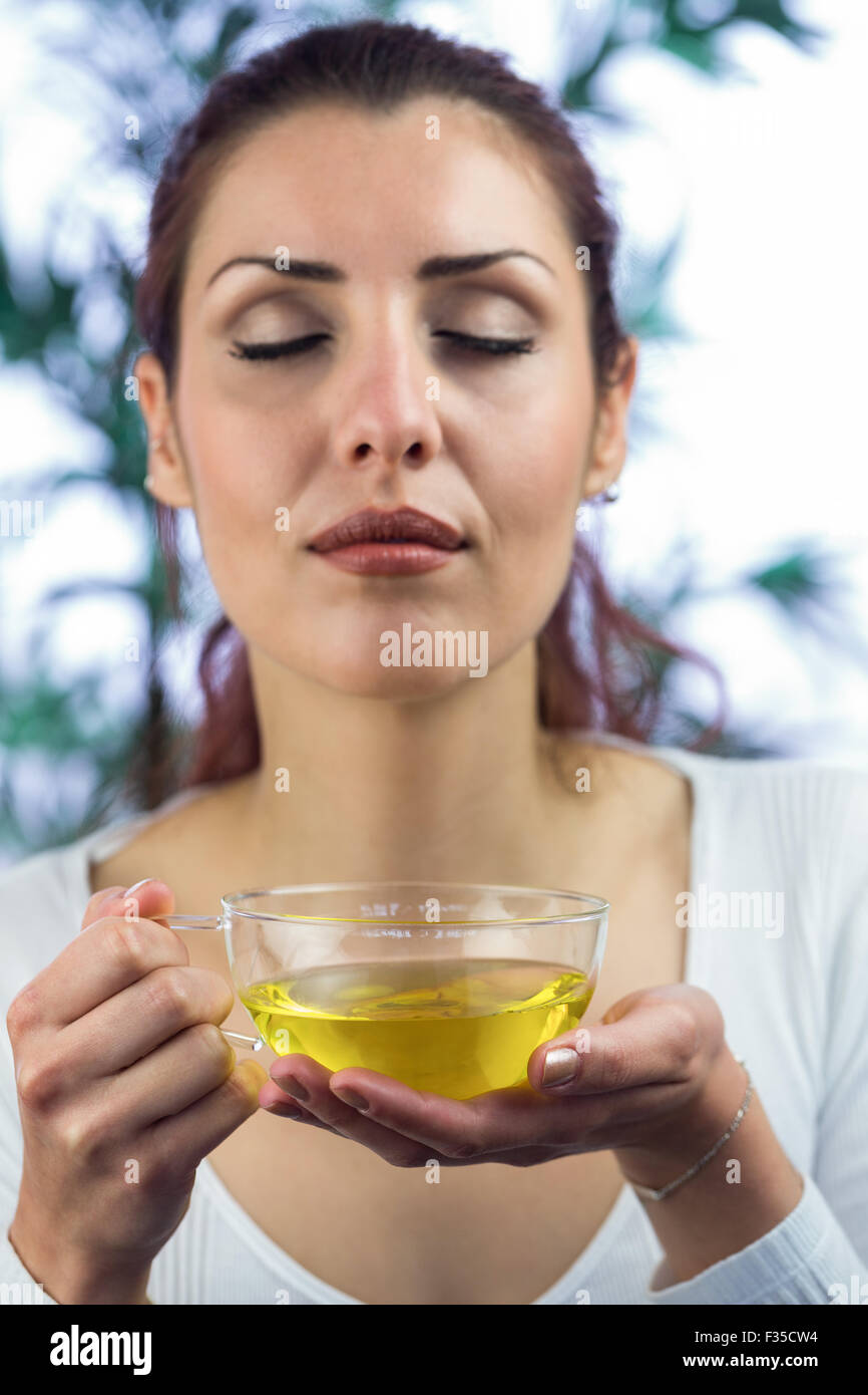 Woman smelling herbal tea Stock Photo - Alamy