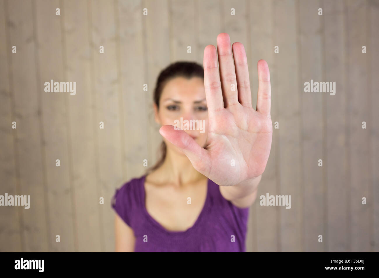 Portrait of woman showing stop sign Stock Photo - Alamy