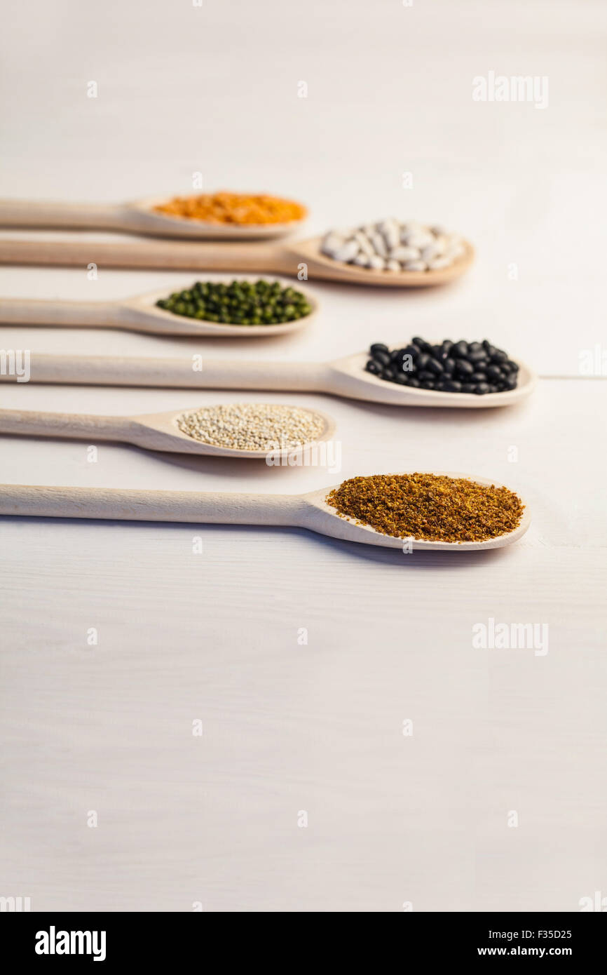 Wooden spoons of pulses and seeds Stock Photo - Alamy
