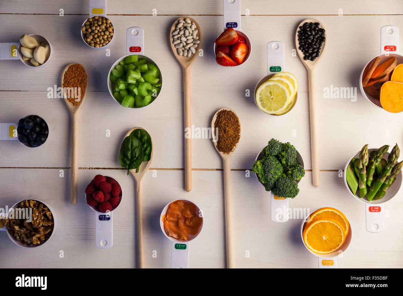Portion cups and spoons of healthy ingredients Stock Photo - Alamy