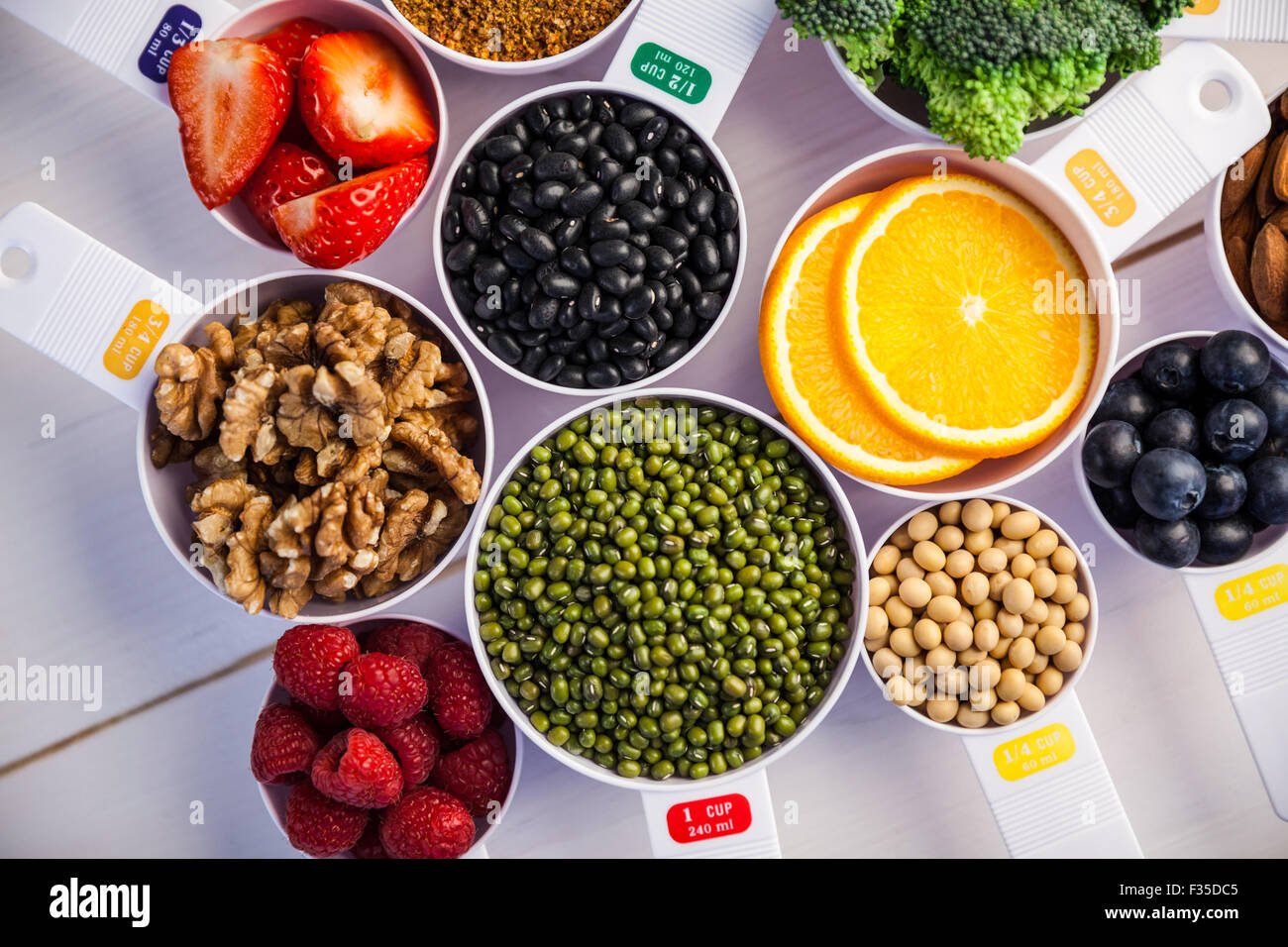 Portion cups and spoons of healthy ingredients Stock Photo - Alamy